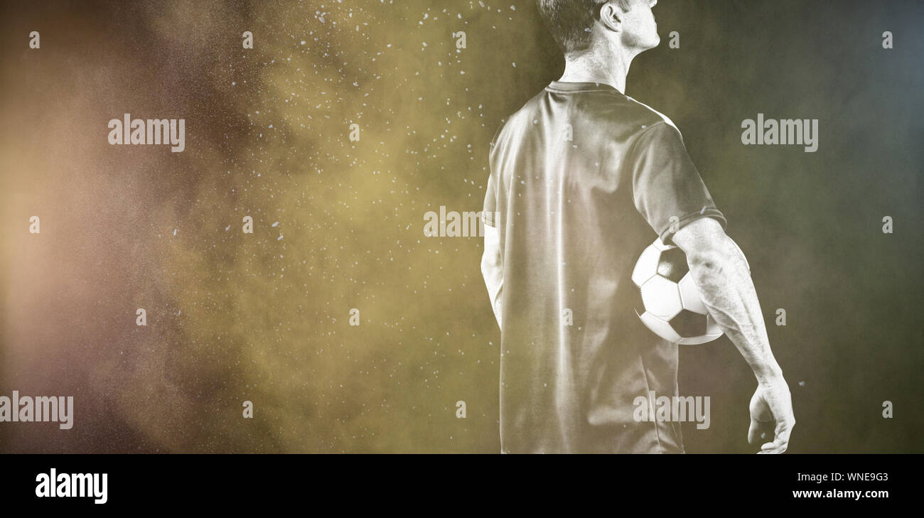 Composite image of focused soccer player Stock Photo - Alamy