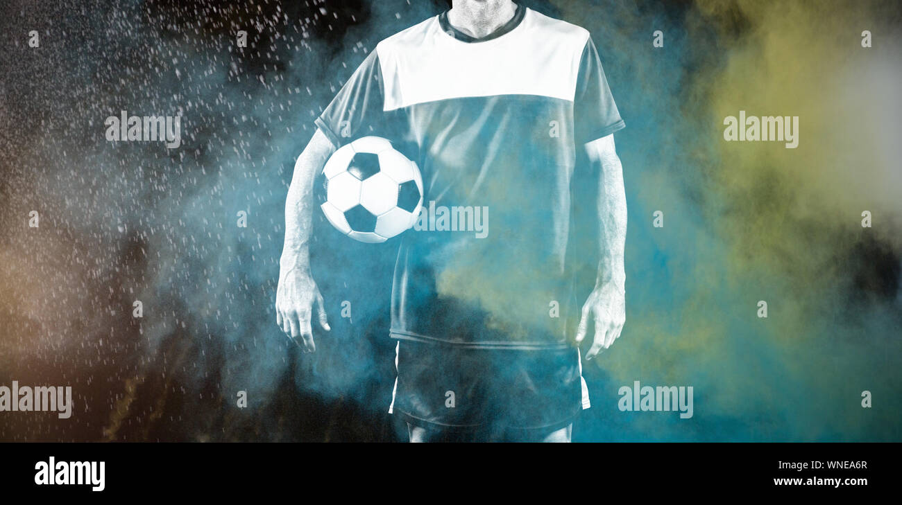 Composite image of focused soccer player Stock Photo - Alamy
