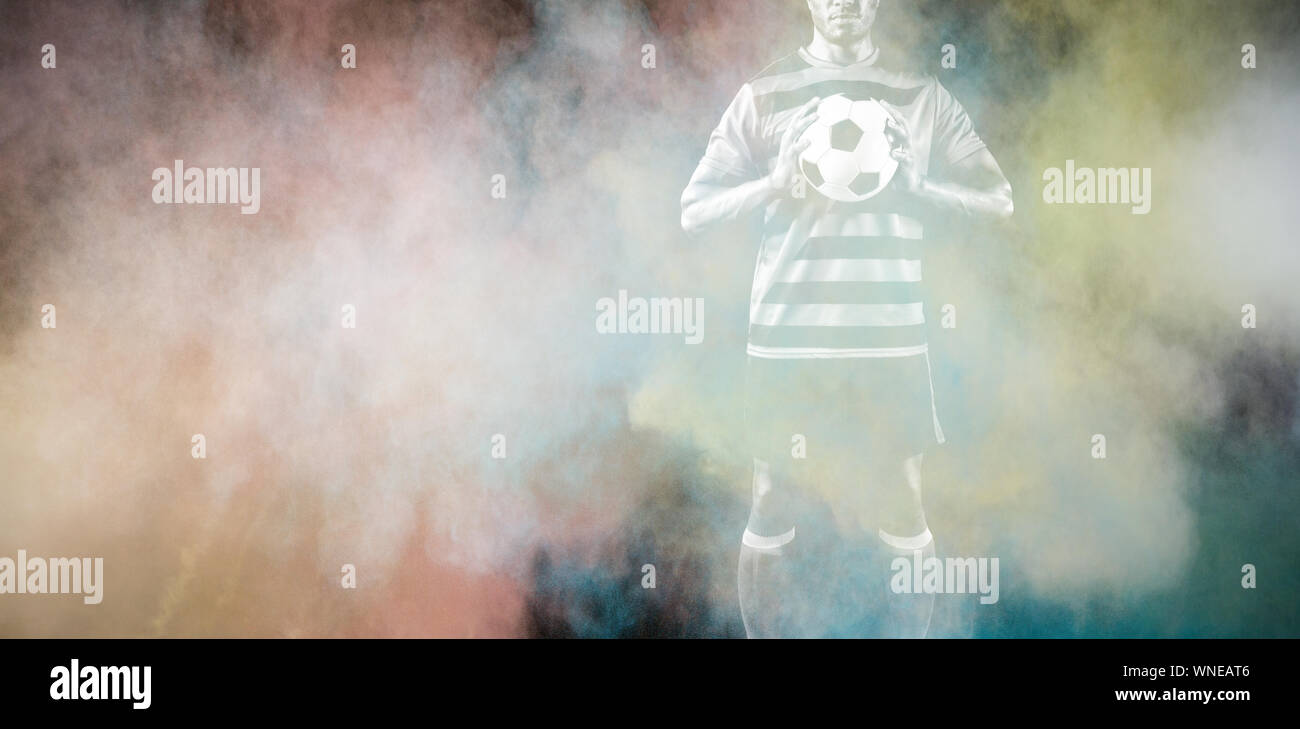Composite image of focused soccer player Stock Photo - Alamy