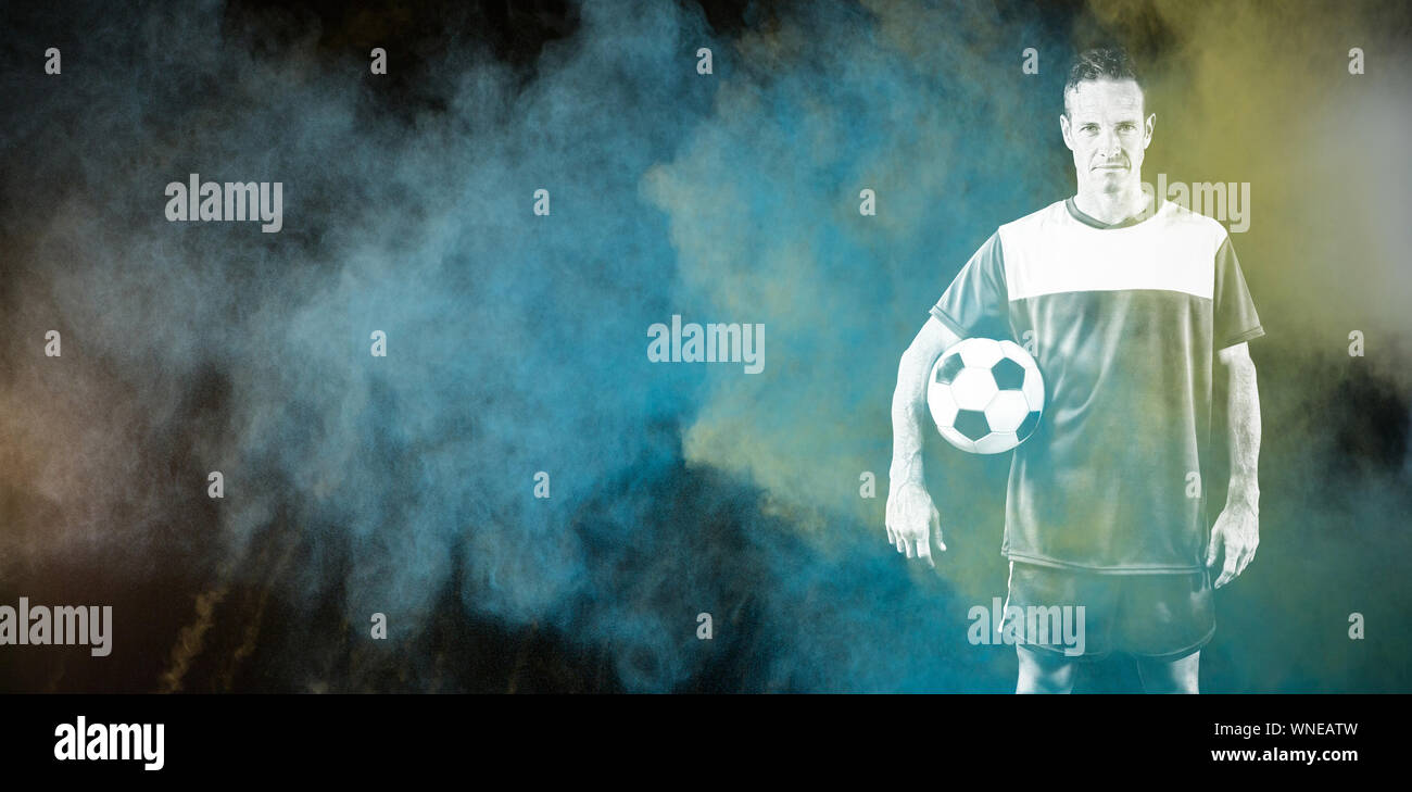 Composite image of focused soccer player Stock Photo - Alamy