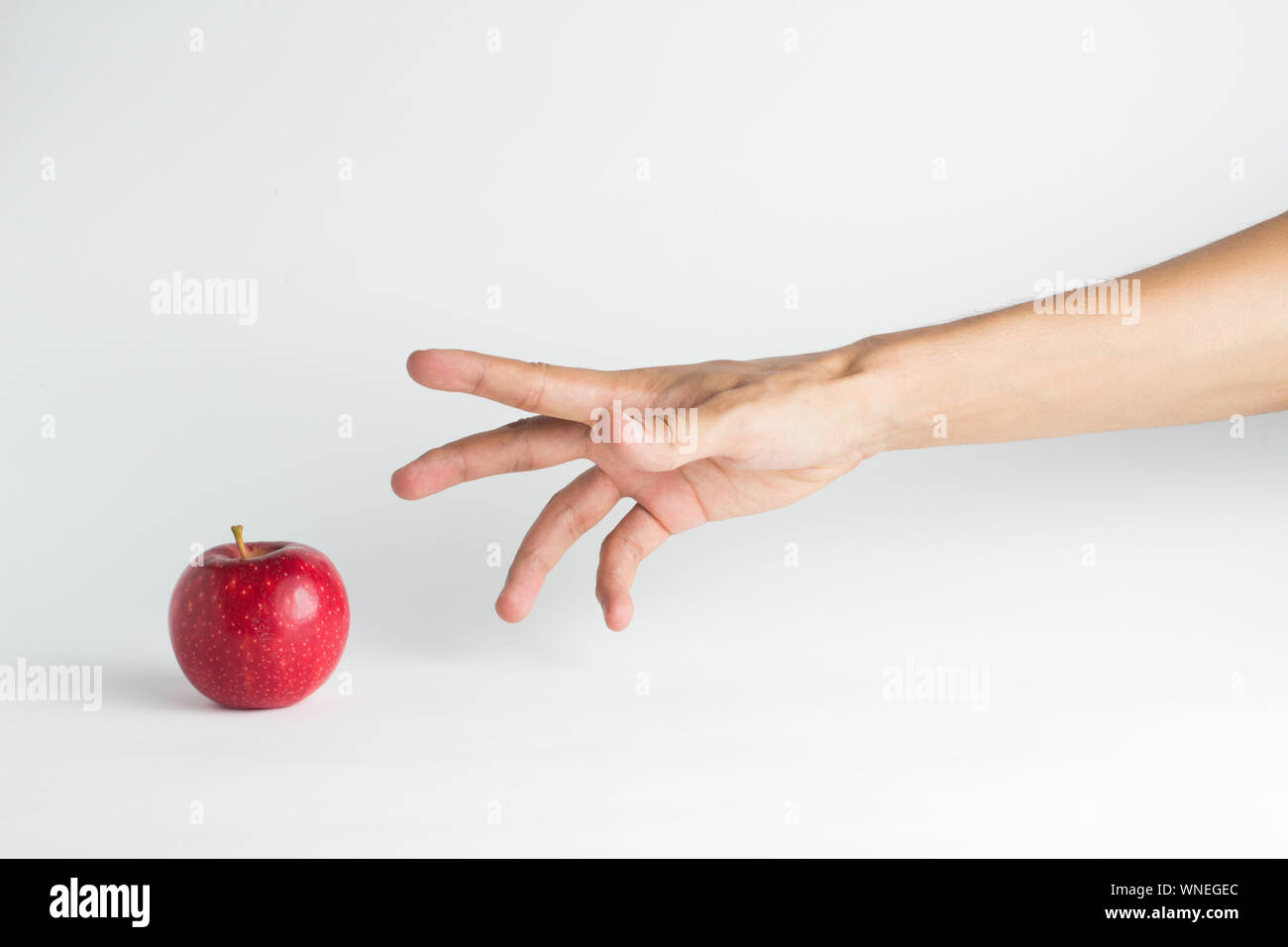 Hand reaching for apple hi-res stock photography and images - Alamy