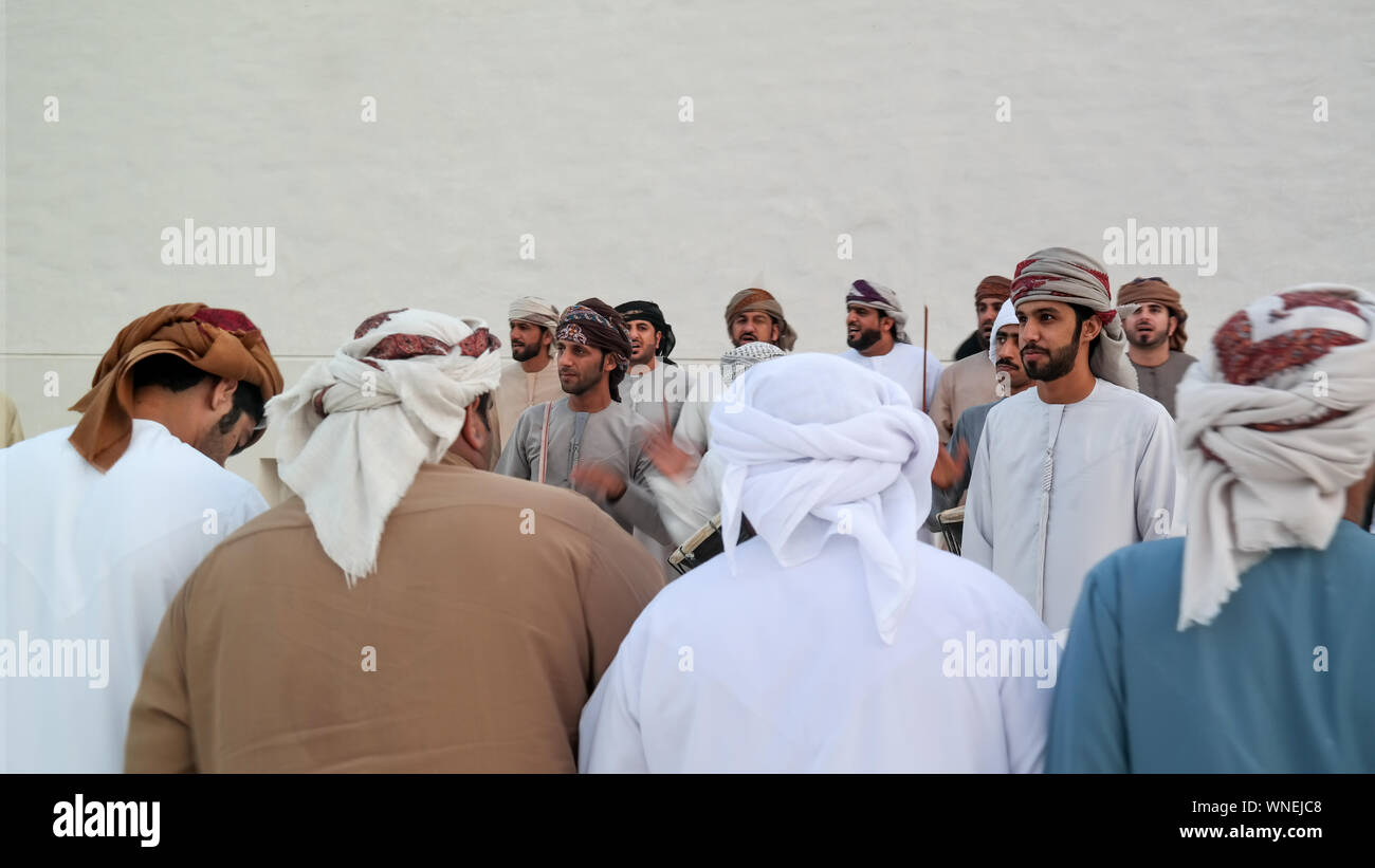 Emirati Men performing the Yowla, a traditional dance in the heritage ...