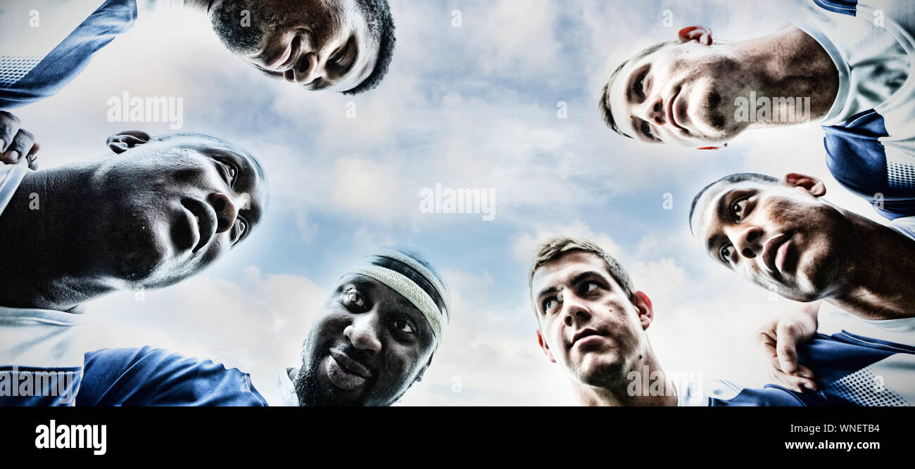 Group of Male rugby players forming huddles in stadium Stock Photo - Alamy