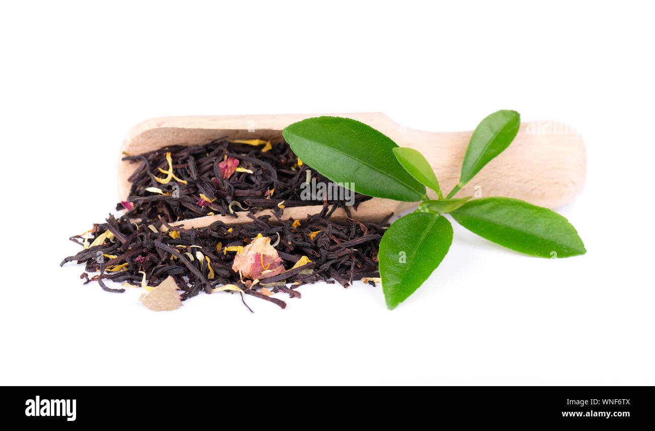 Black ceylon tea with rose petals, cornflowers and sunflower, isolated ...