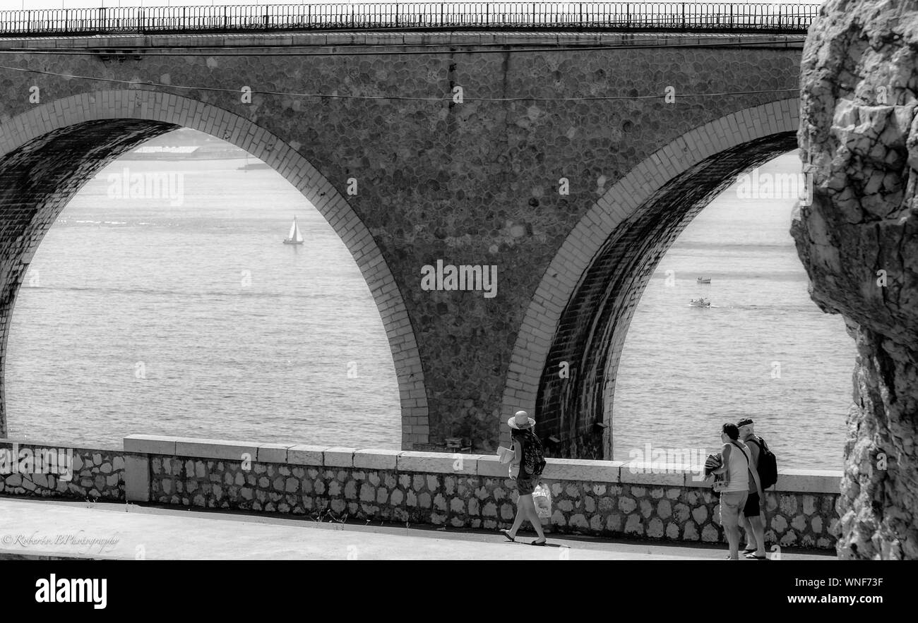 People Walking Against Arched Bridge Over River Stock Photo - Alamy