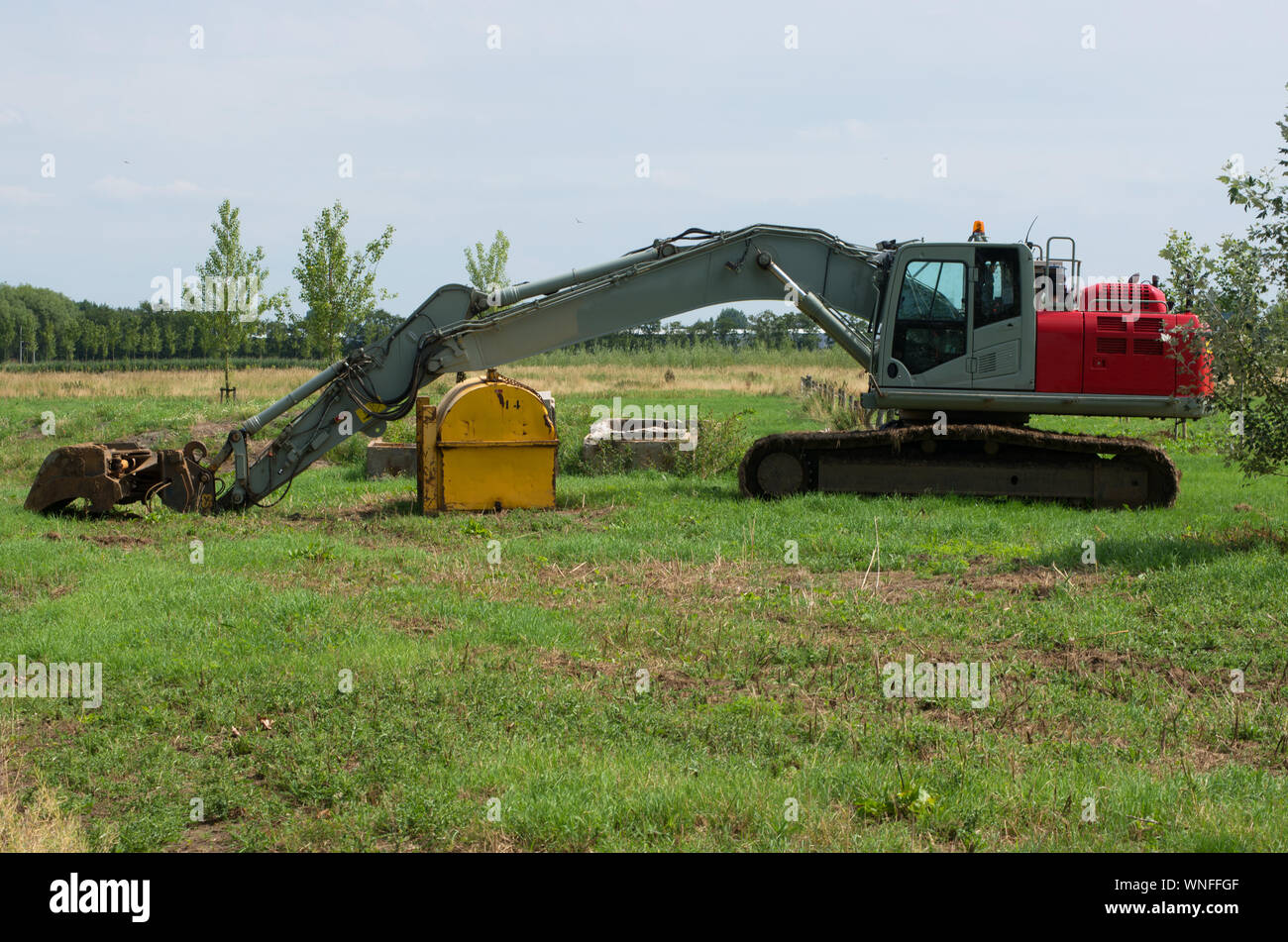 Caterpillar excavator with arm on the ground Stock Photo - Alamy