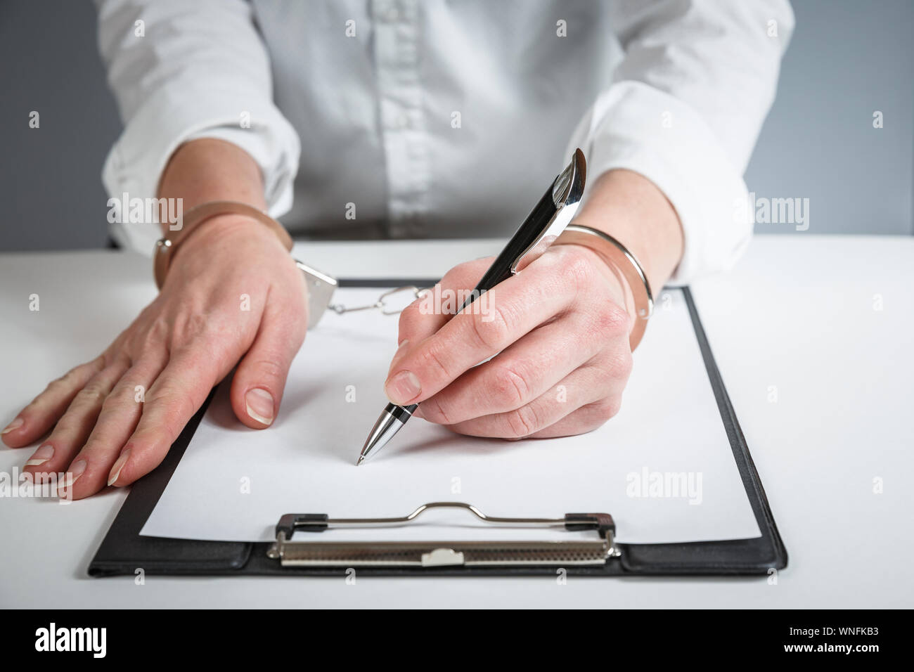 Female hands in handcuffs fill out police report recognition Stock ...