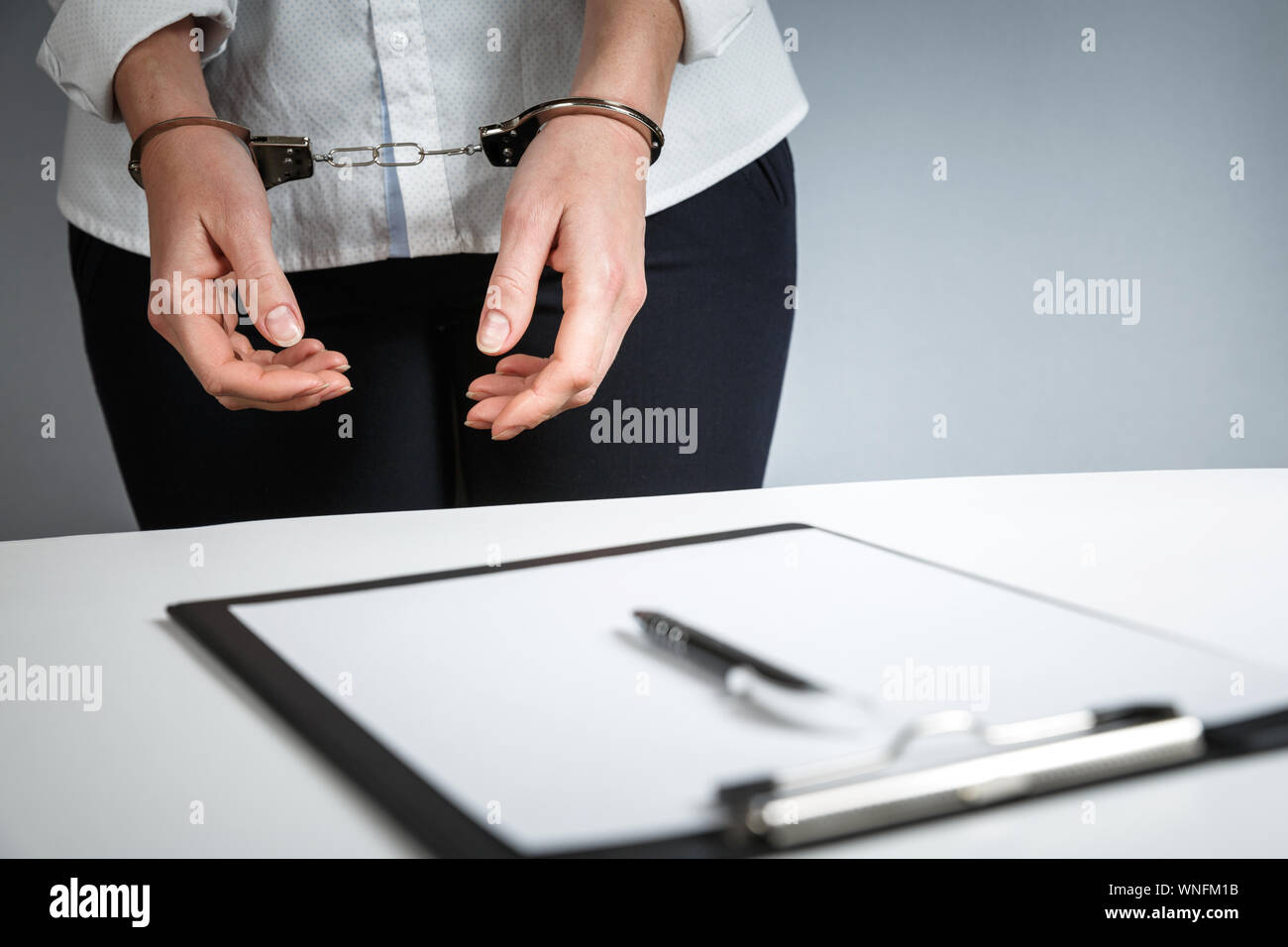 Female hands in handcuffs fill out police report recognition Stock ...