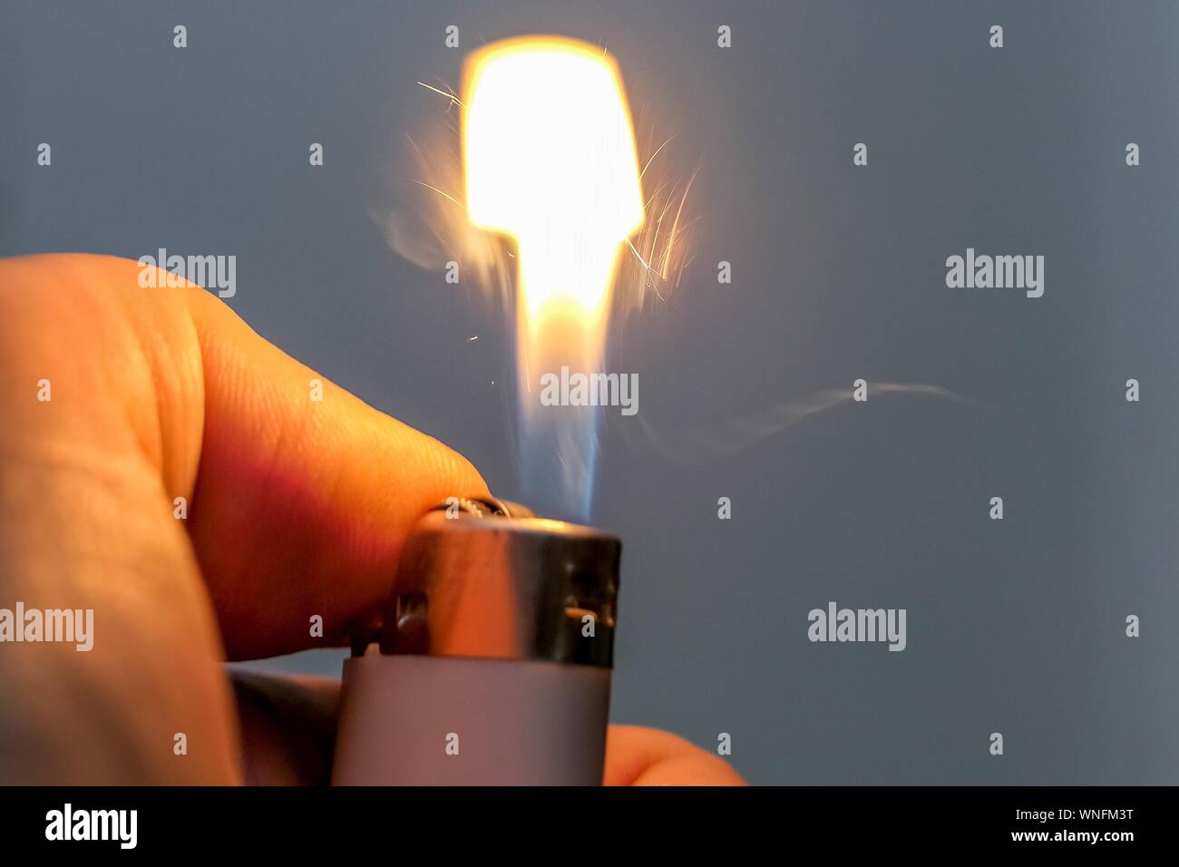 Hand holding lit lighter cigarette lighter hi-res stock photography and ...