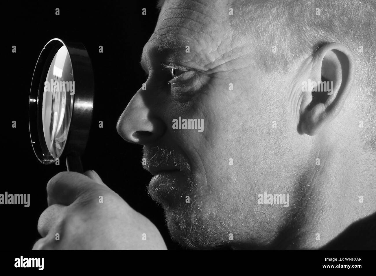Adult holding magnifying glass Black and White Stock Photos & Images ...