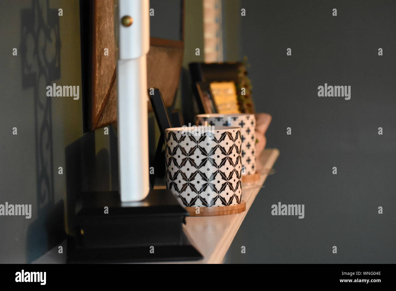 Close picture of mantle with various objects and picture frames visible ...