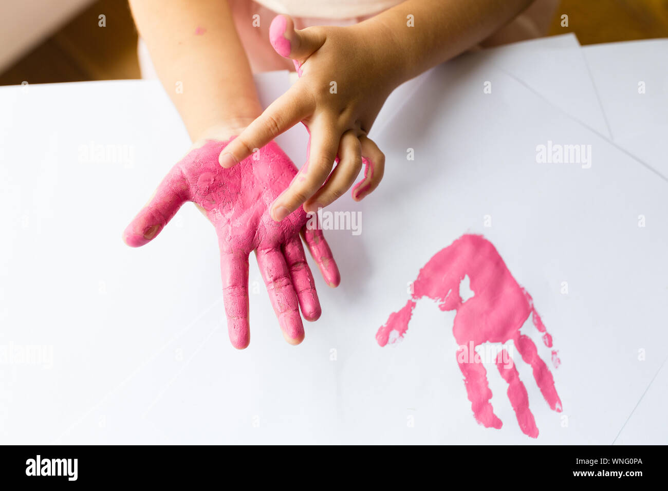 Kid hands and Handprint pink color. Flat lay, top view, overhead ...