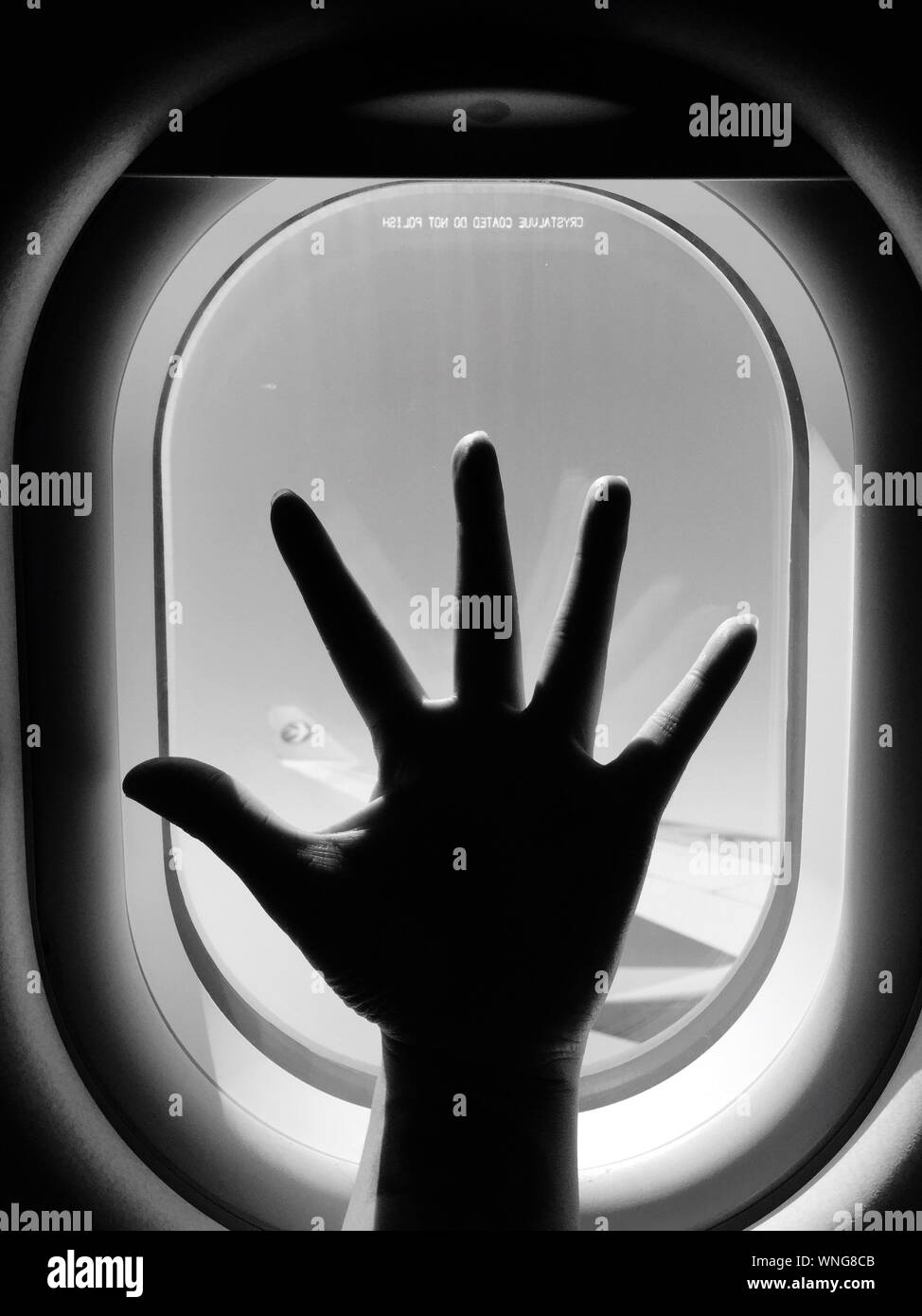 Human hand on airplane window hi-res stock photography and images - Alamy
