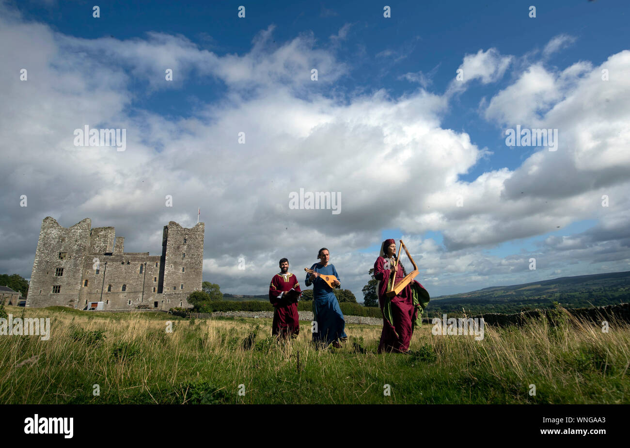 (Left to right) Richard de Winter, Paul Leigh carrying a Gittern and ...