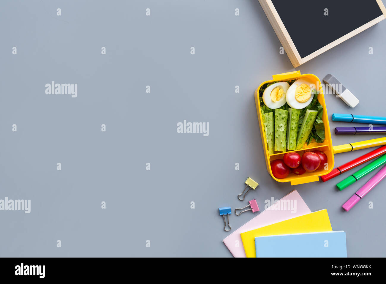 School supplies and lunch box with sandwich and vegetables. Back to ...