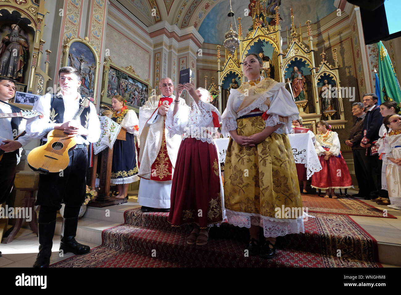 People dressed in traditional regional folk costumes in the church at ...