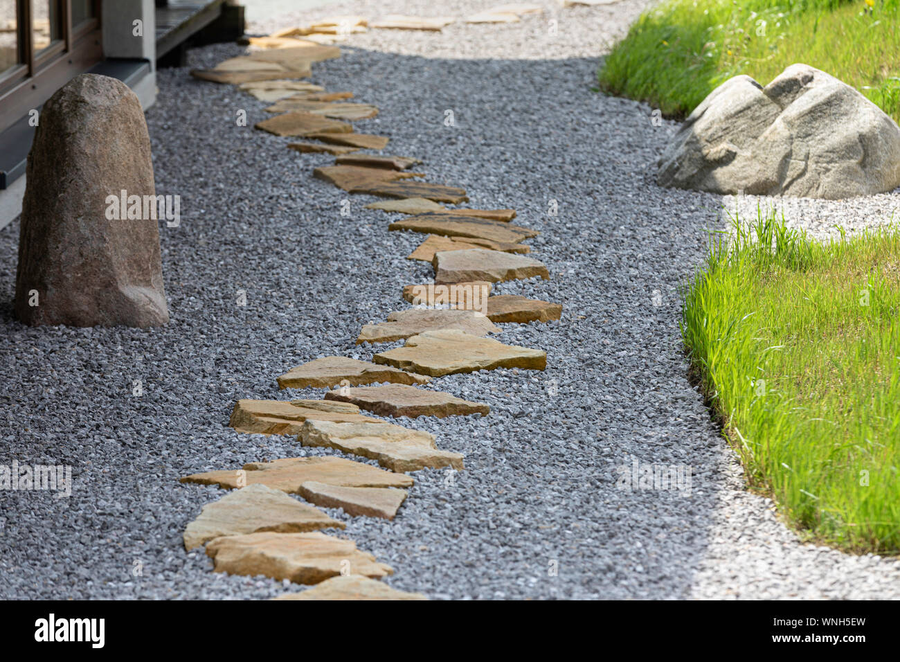 A stone path in the garden in front of the house Stock Photo - Alamy