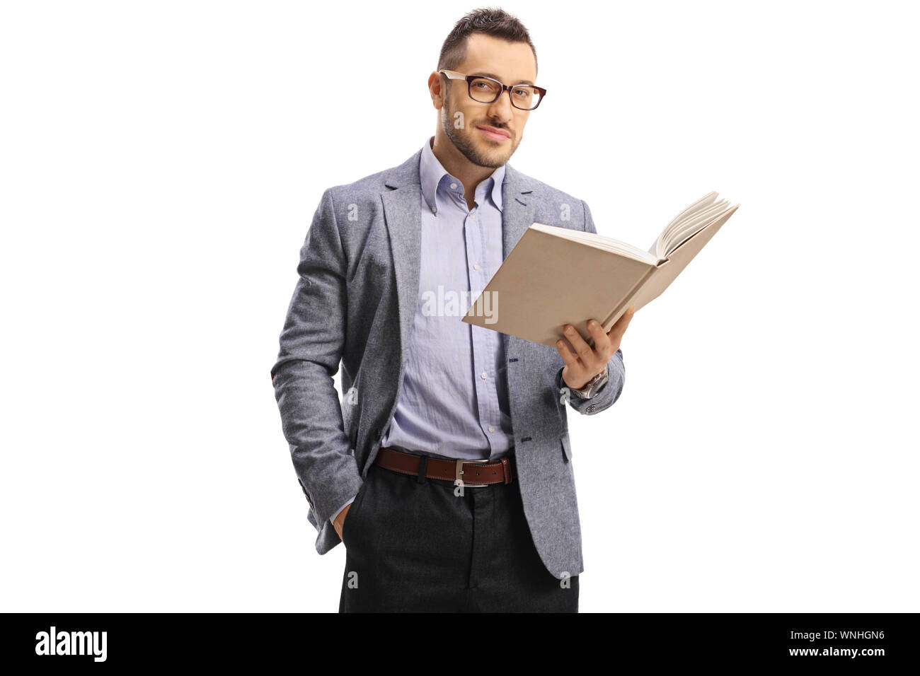 Young elegant man standing and holding an open book isolated on white ...