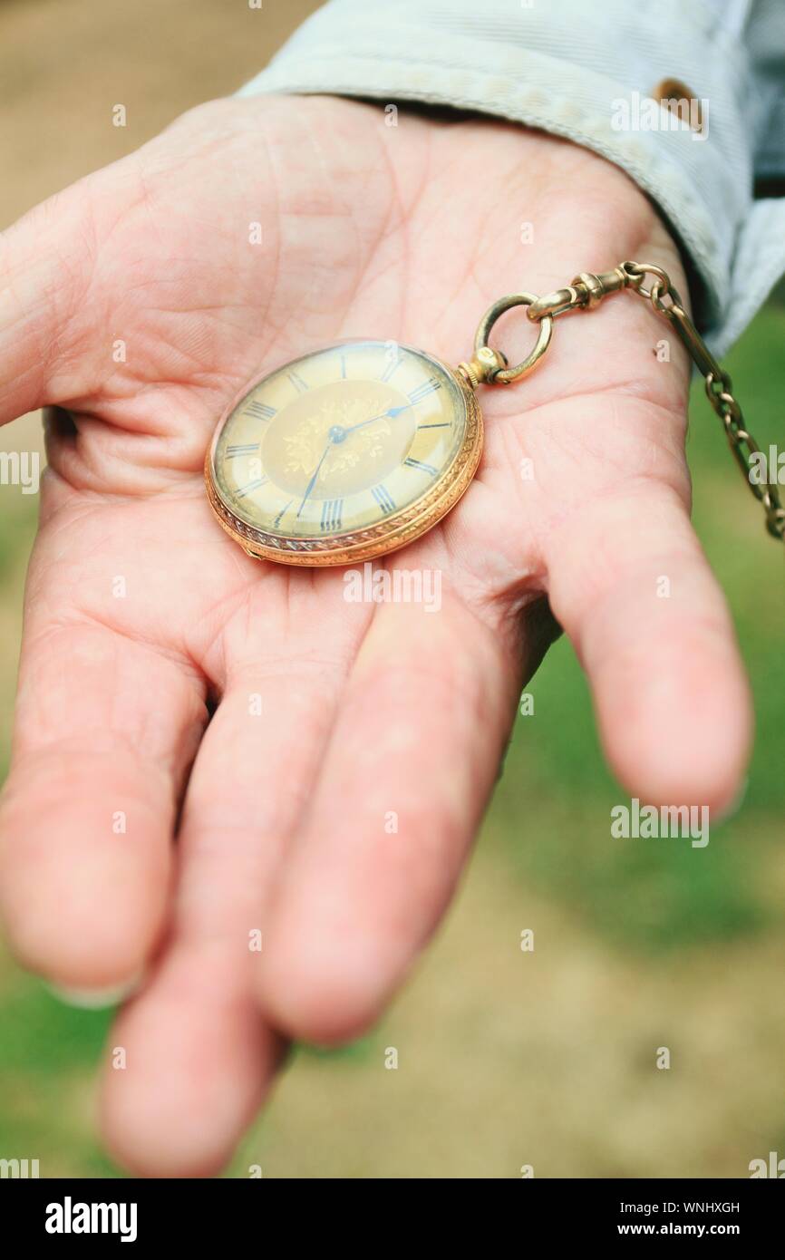 Hand holding watch hi-res stock photography and images - Alamy