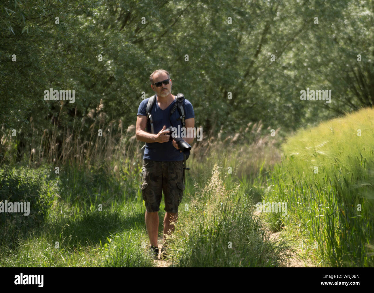 Man walking with camera hi-res stock photography and images - Alamy