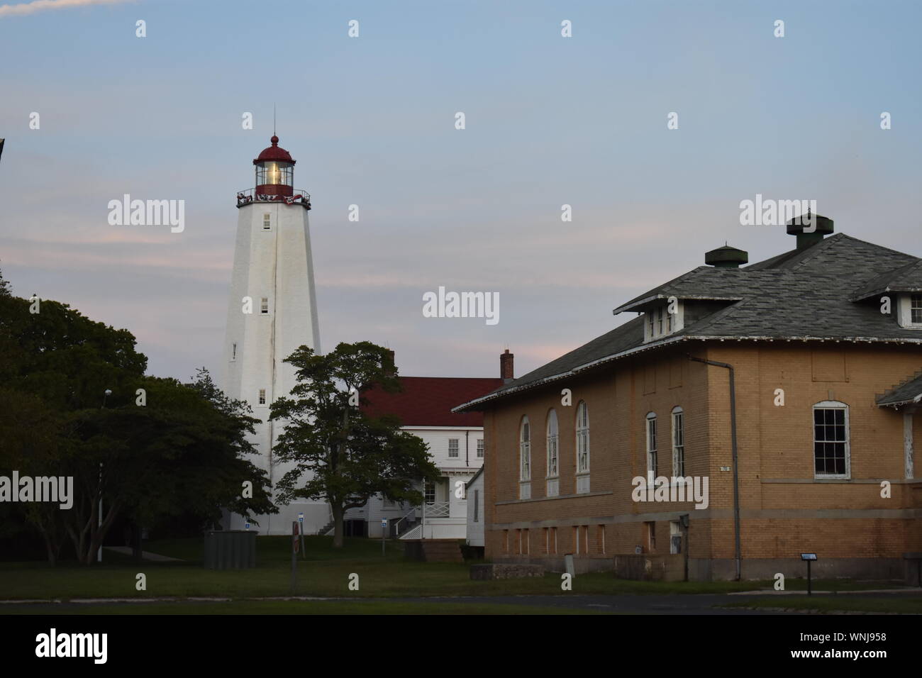 Lighthouse in Sandy Hook, New Jersey, at dusk, with the light turned on ...