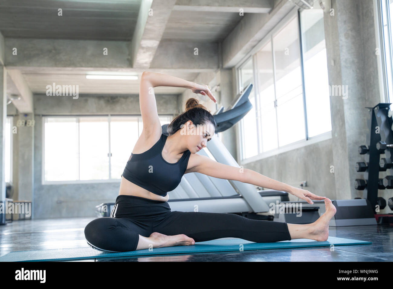 Beautiful sport women make stretch body in gym, Healthy concept Stock ...