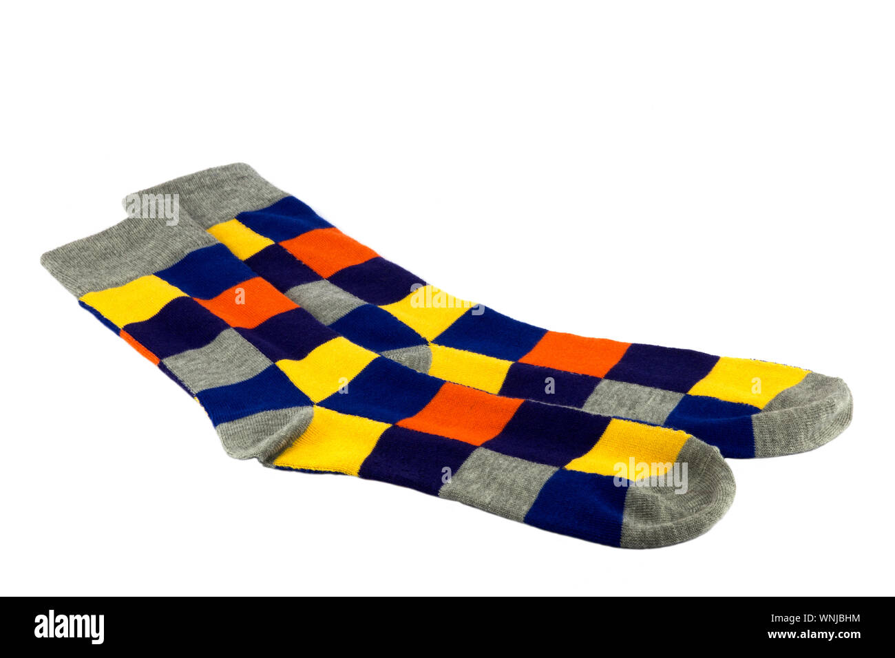 Multi-coloured checkered socks isolated against a white background ...