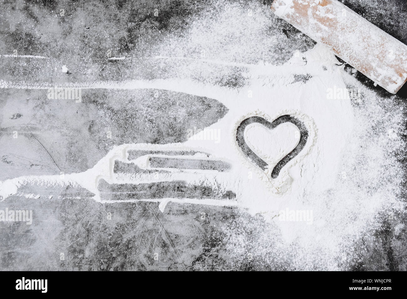 Baking background. Heart of flour and rolling pin on gray table. Bake ...