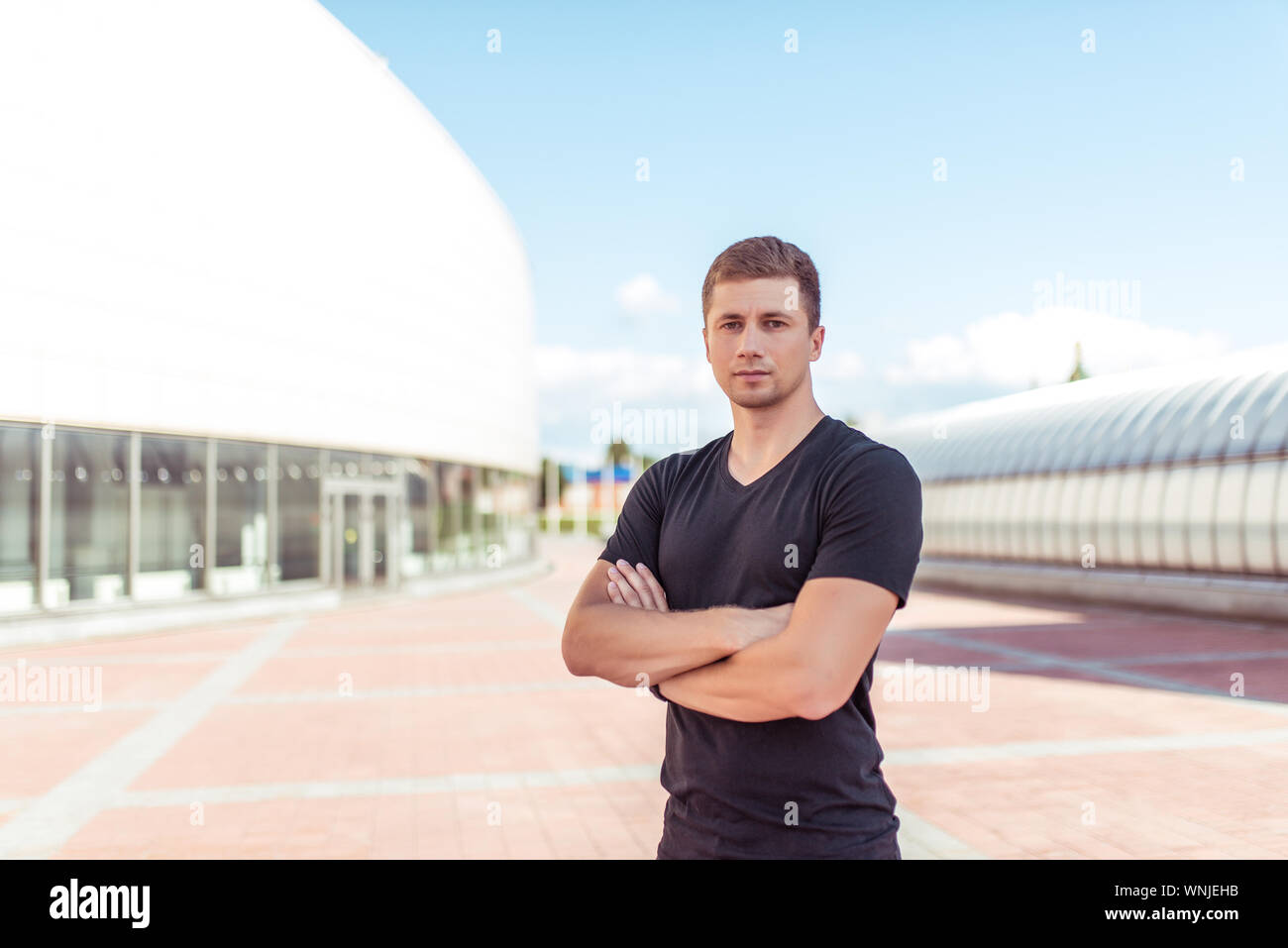 Male athlete, city in summer stands confident position, strength of ...