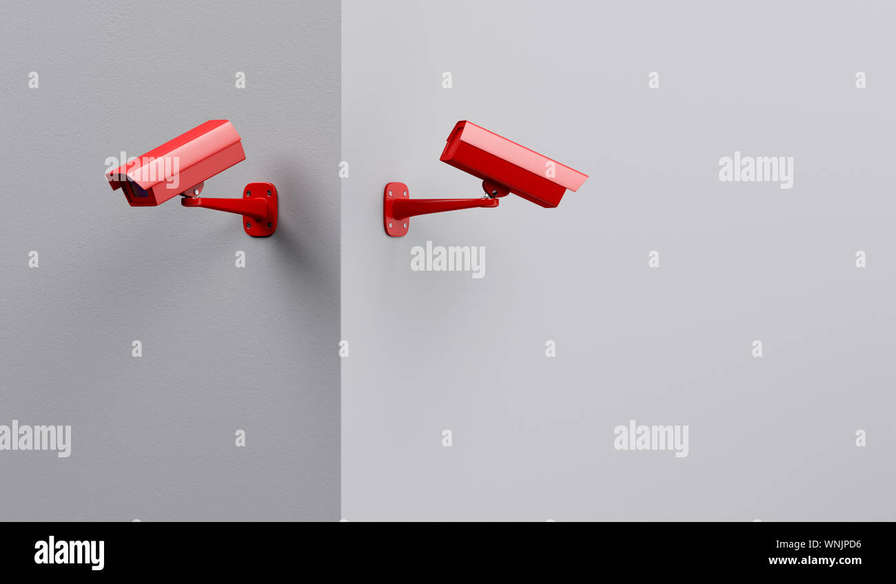 Two red security cameras on the wall Stock Photo - Alamy