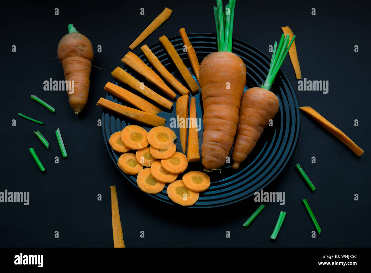 Carrot cut in different shapes on a black plate Stock Photo - Alamy