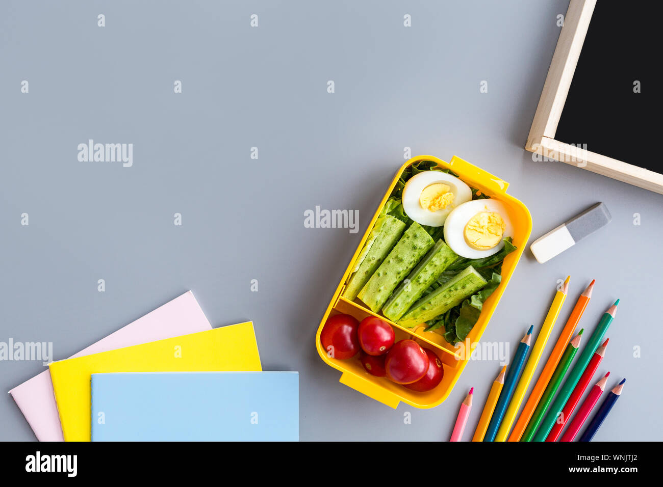 School supplies and lunch box with sandwich and vegetables. Back to ...