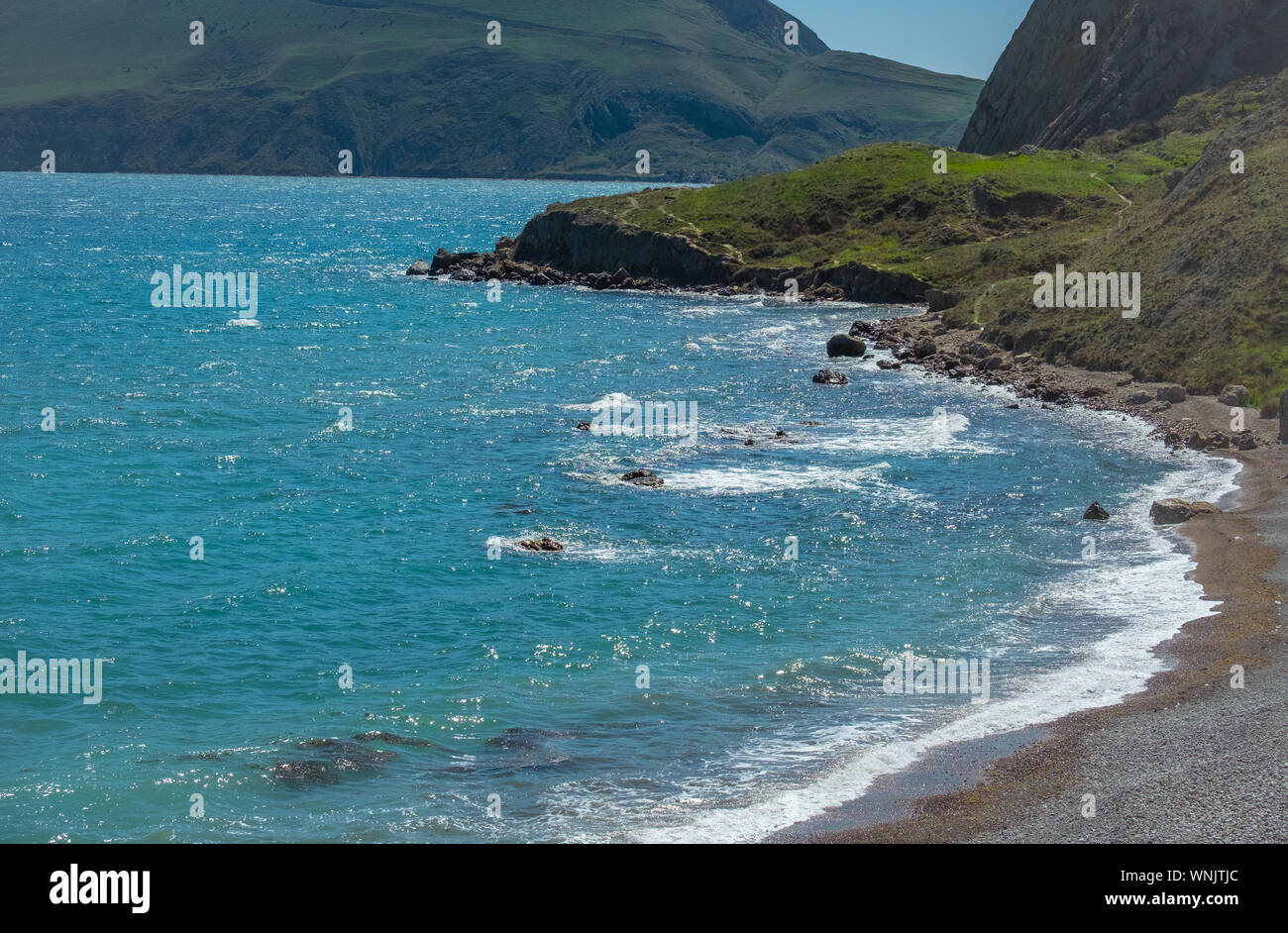 Beautiful green slopes of the mountains by the sea. Bright colors of ...