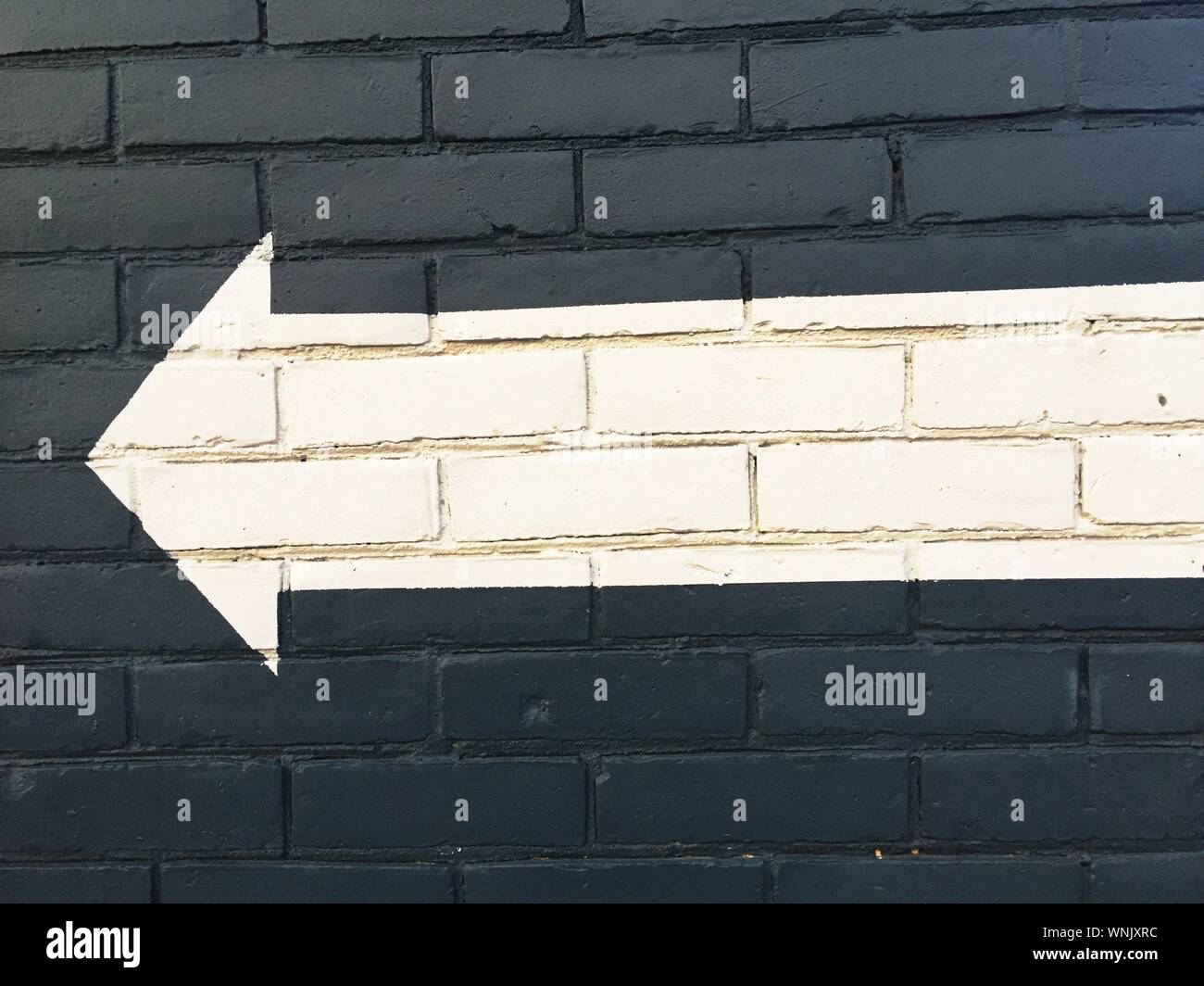 Black sign white brick wall hi-res stock photography and images - Alamy