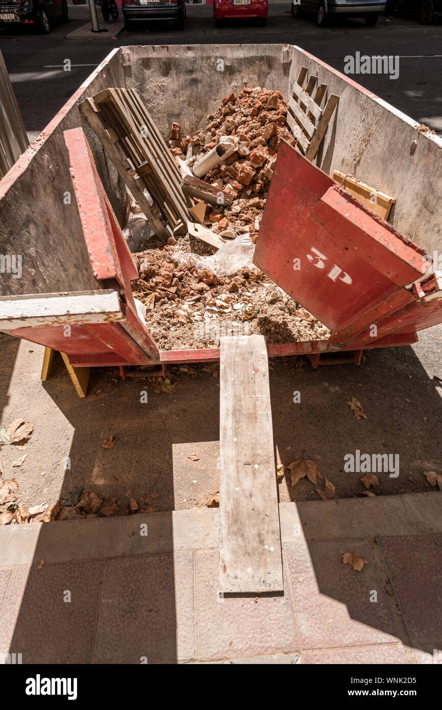 Skip with rubble on the road hi-res stock photography and images - Alamy