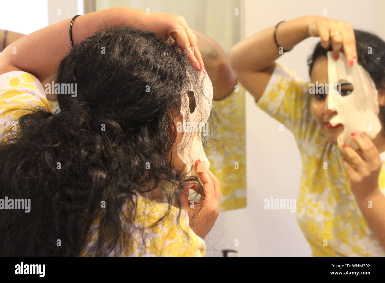 Removing the mask hi-res stock photography and images - Alamy
