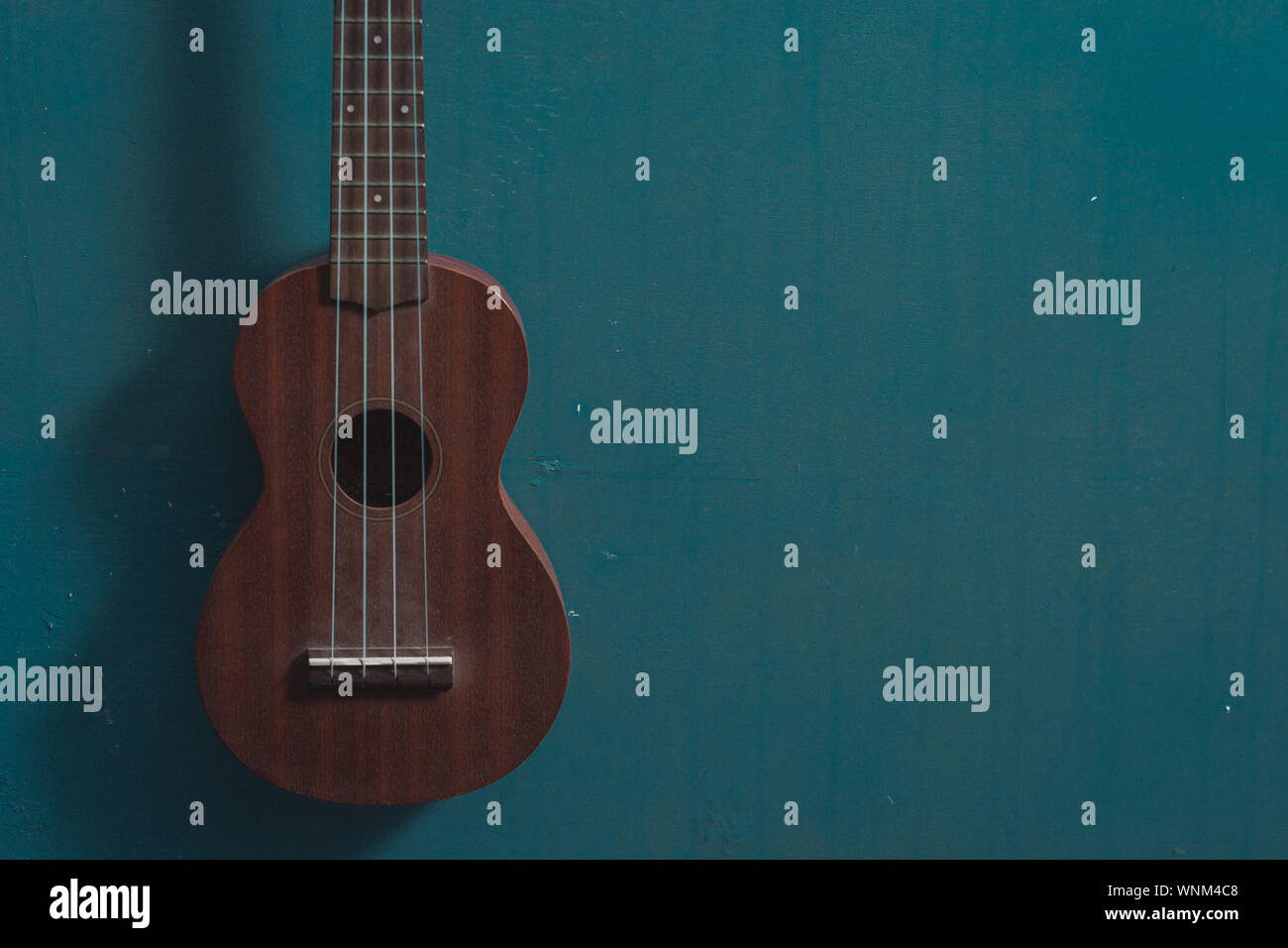 ukulele on close up isolated blue background Stock Photo - Alamy