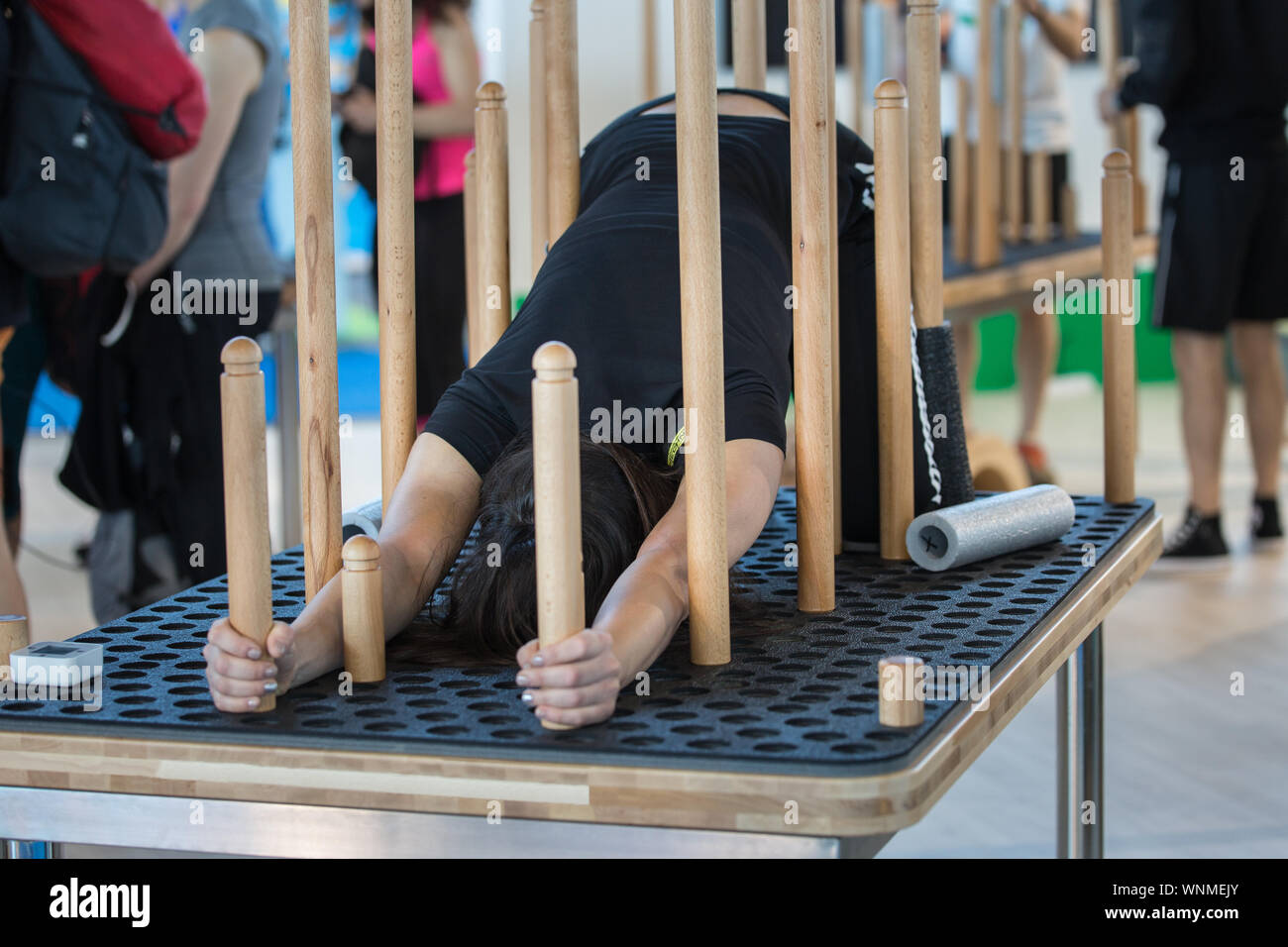 Girls doing Fitness Exercises on a Perforated Table with Movable Wooden ...
