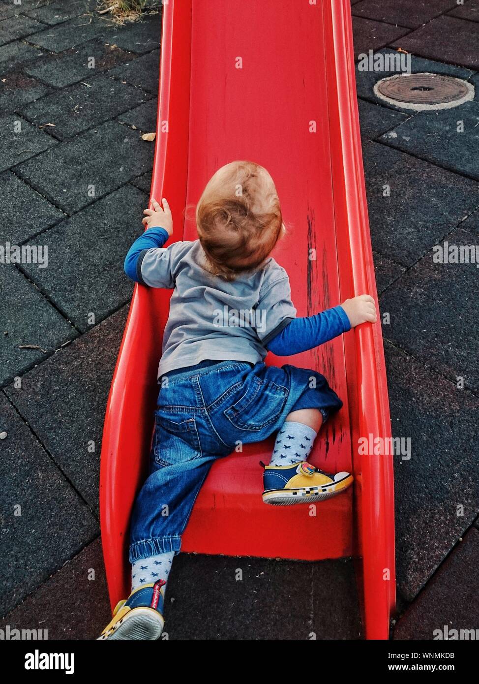 Baby climbing slide hi-res stock photography and images - Alamy