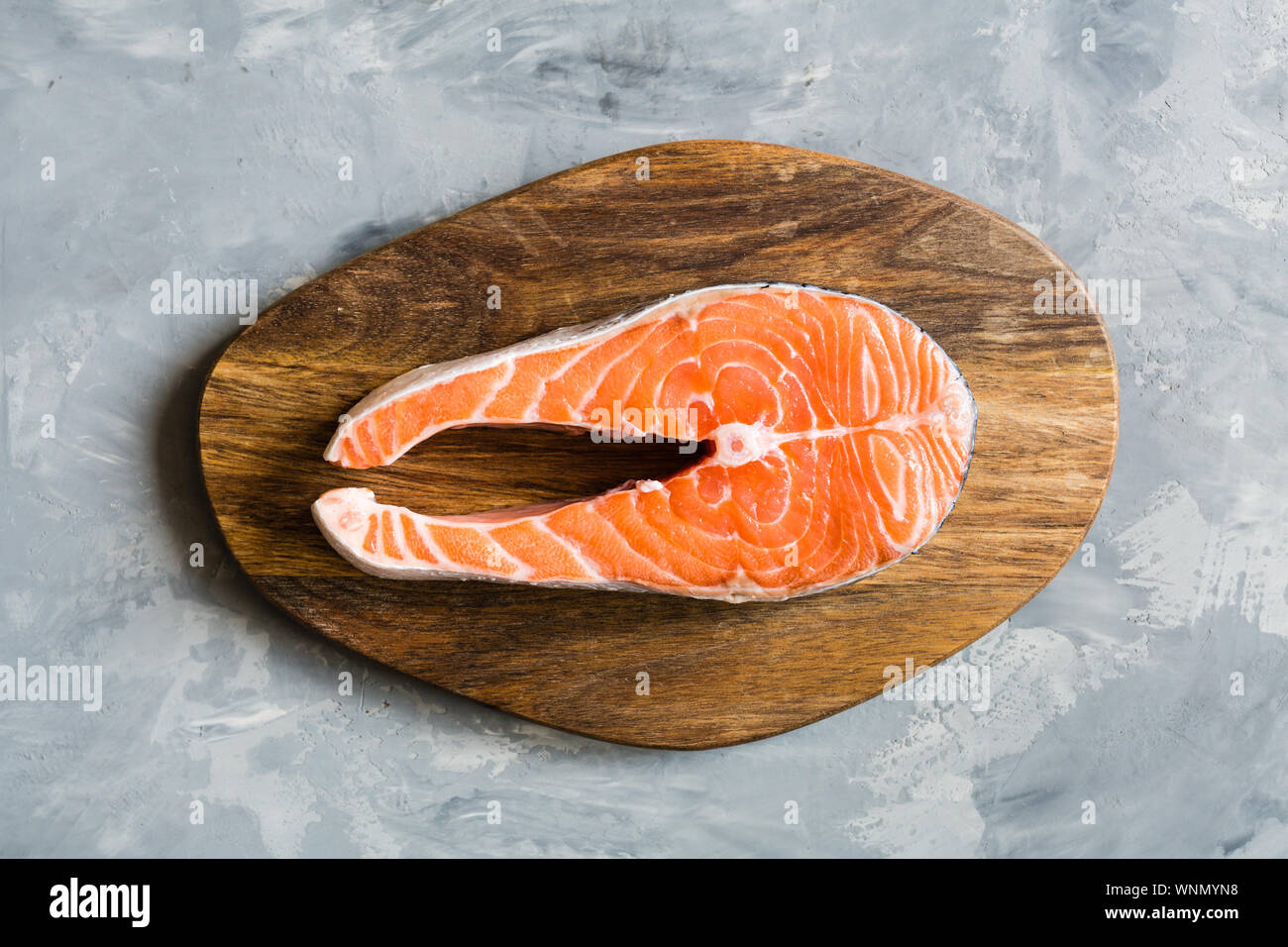 Fresh raw salmon fish steak on dark stone background. Creative layout ...