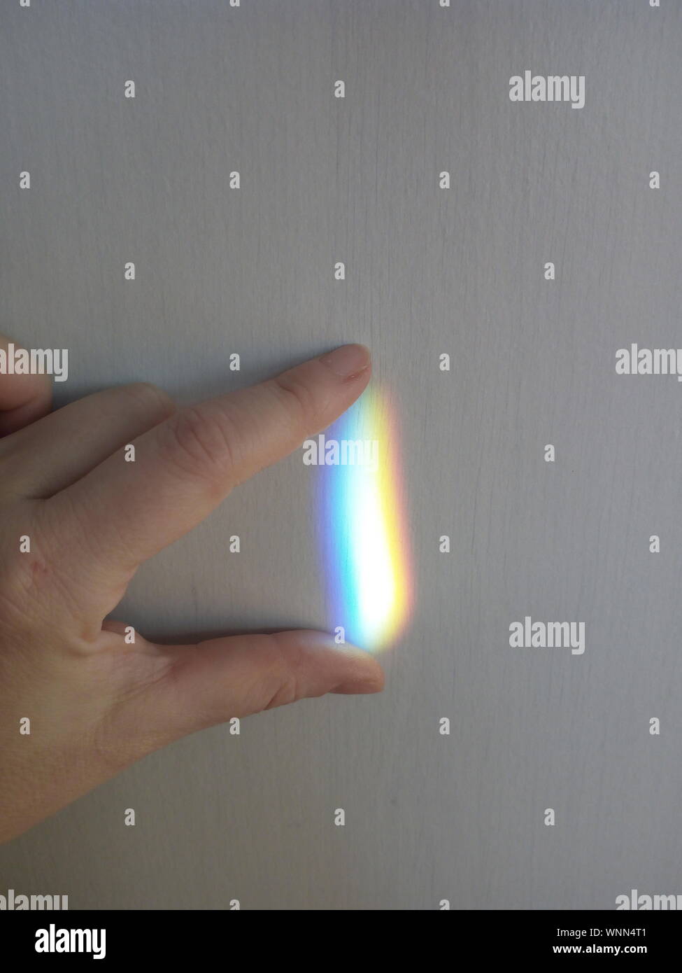 Rainbow touching hand hi-res stock photography and images - Alamy