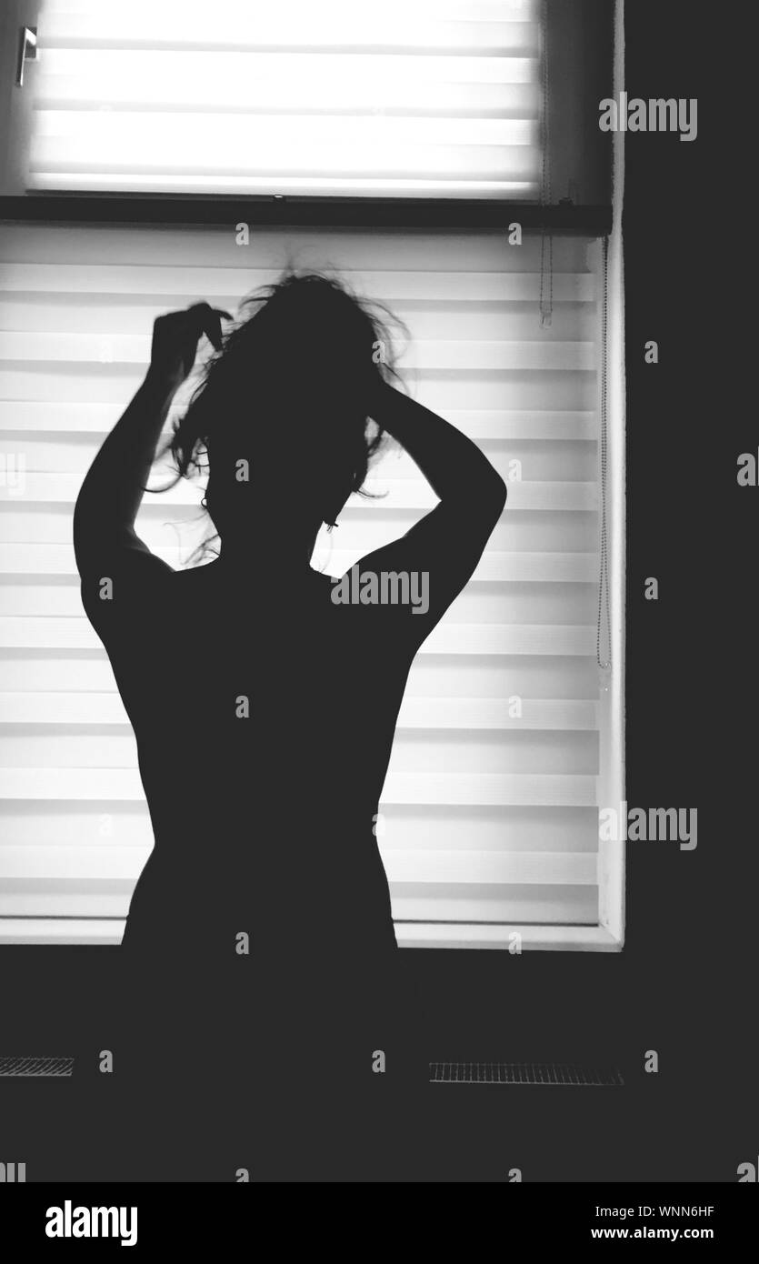 Silhouette Woman Looking Through Window Stock Photo - Alamy