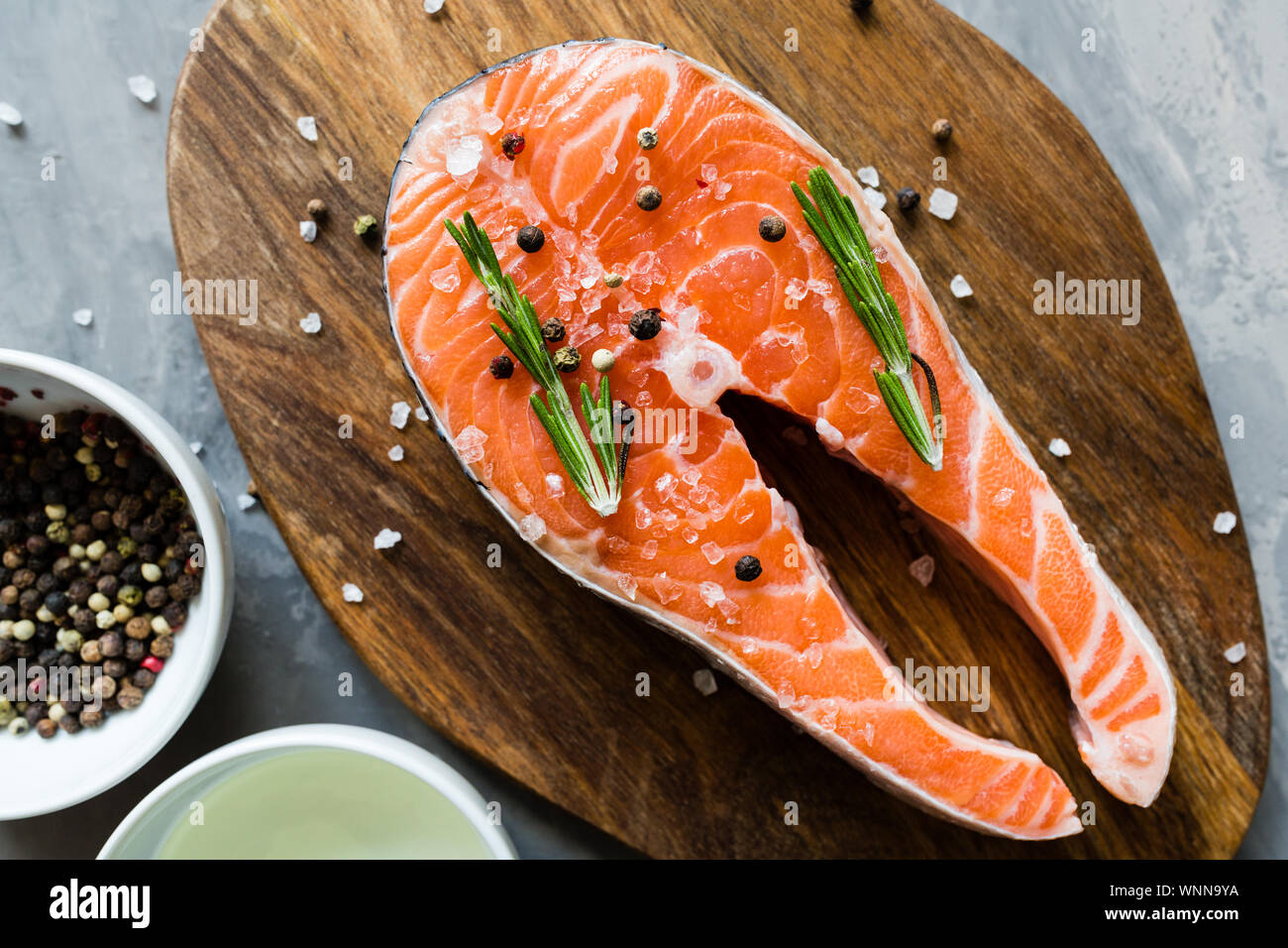 Fresh raw salmon fish steak with spices on dark stone background ...