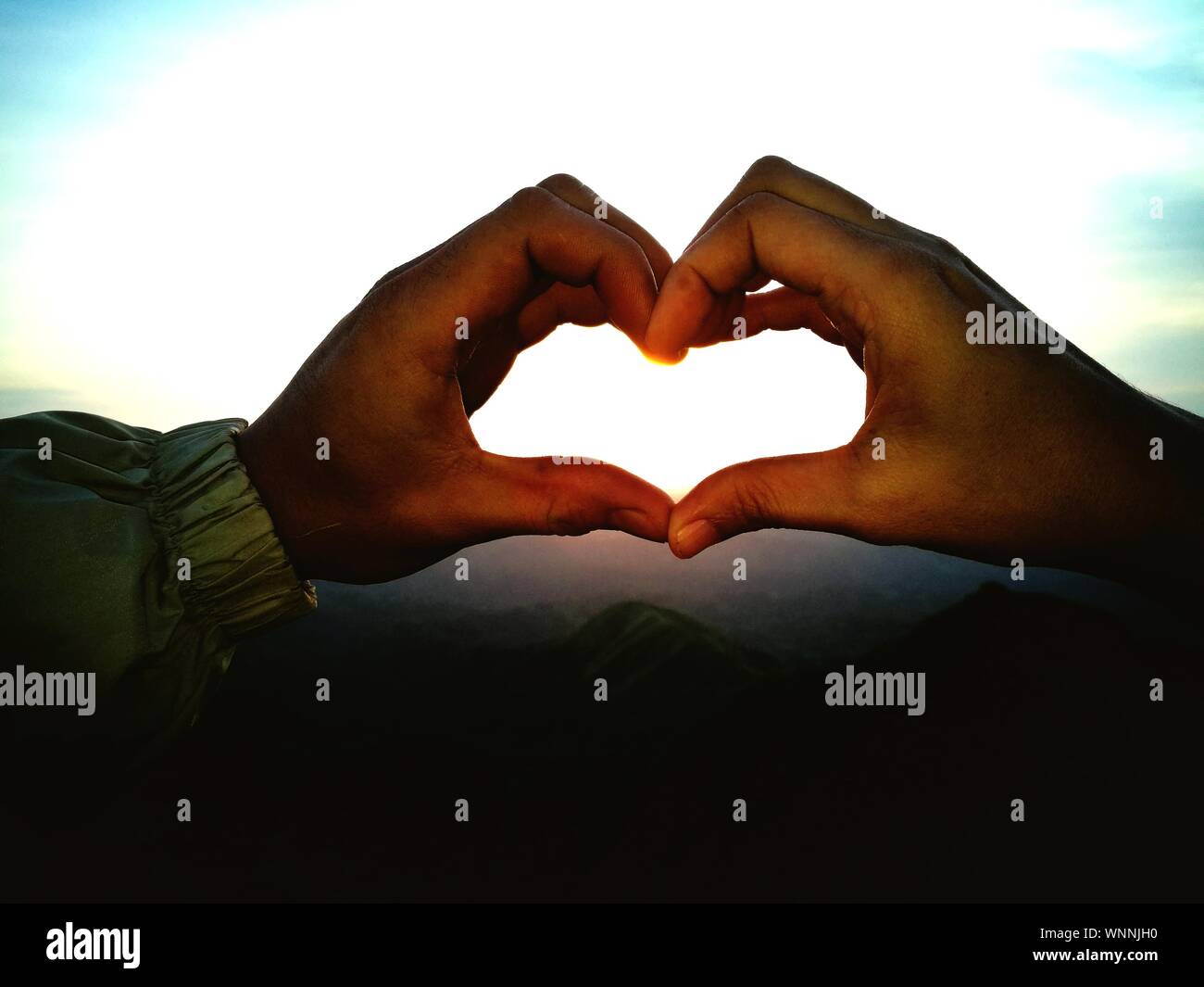 One heart with two hands hi-res stock photography and images - Alamy