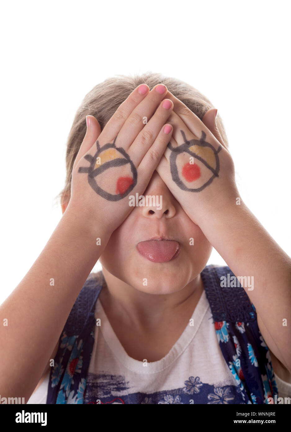 Little girl with cartoon eyes drawn on hands making goofy face Stock ...