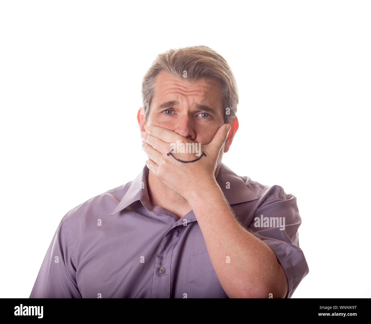 Man hiding his true feelings with a smile drawn on his hand Stock Photo ...