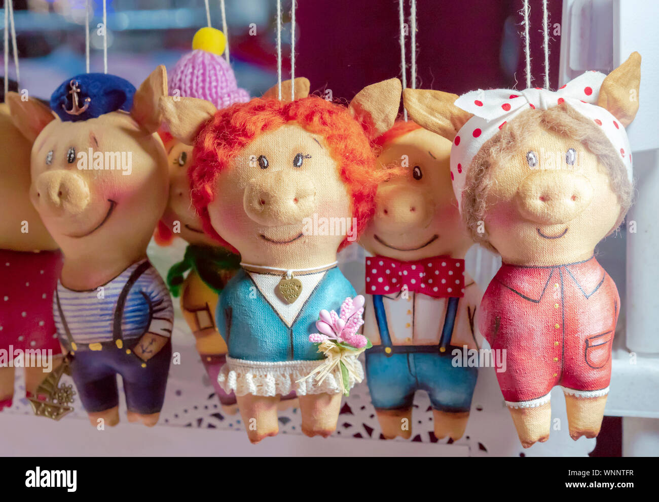 Soft toys piglets in different clothes on the counter of a children's ...