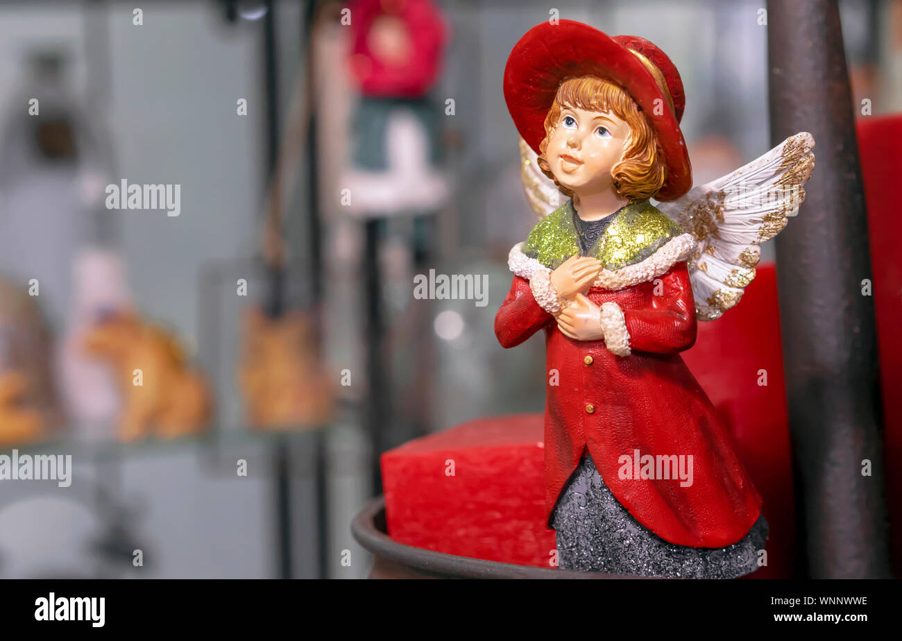 Vintage figurine of a girl in a red cloak with angel wings Stock Photo ...