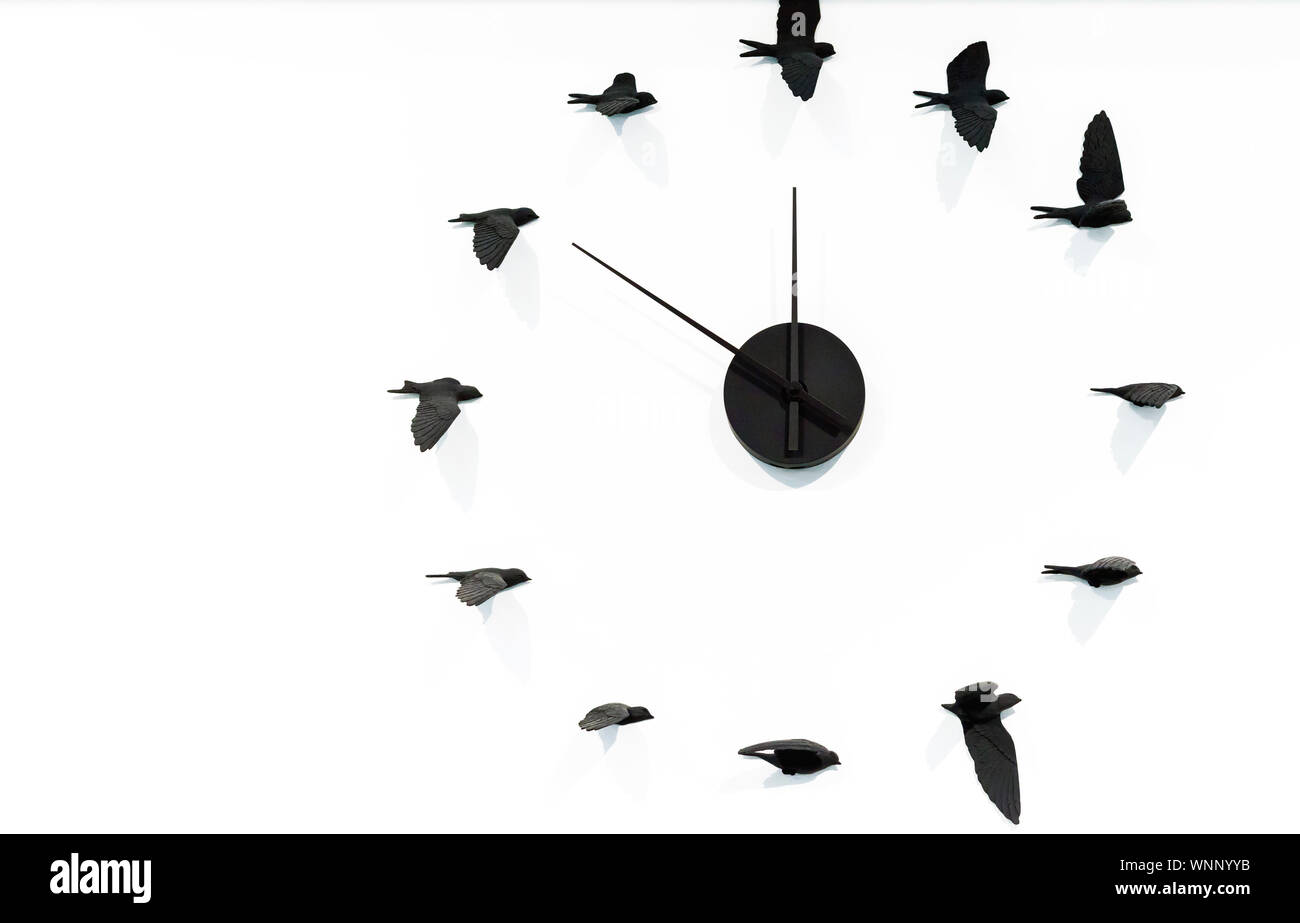 Quartz clock with black birds on a white wall Stock Photo - Alamy