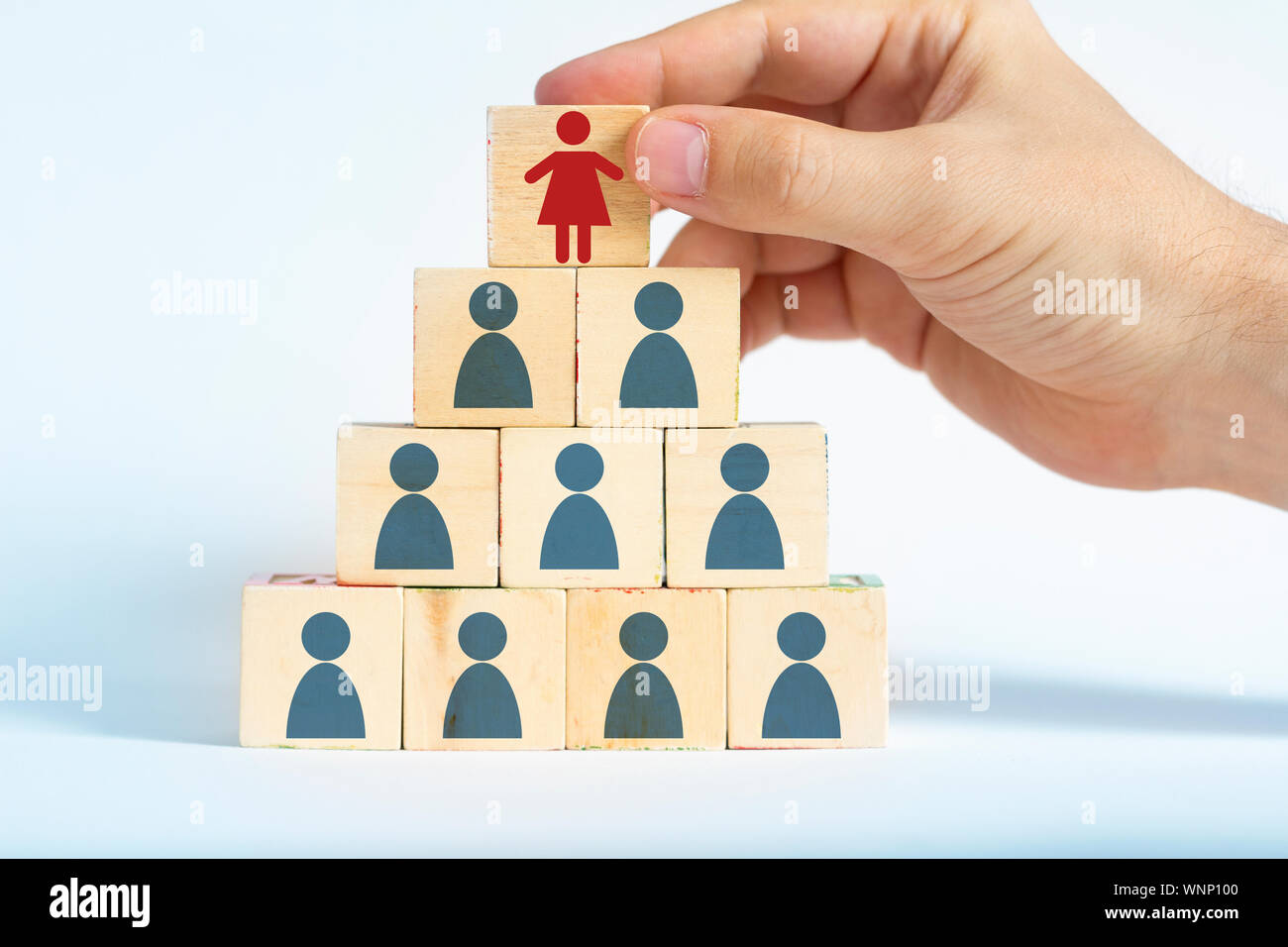 human resources manager is selecting a female worker atop a pyramid ...